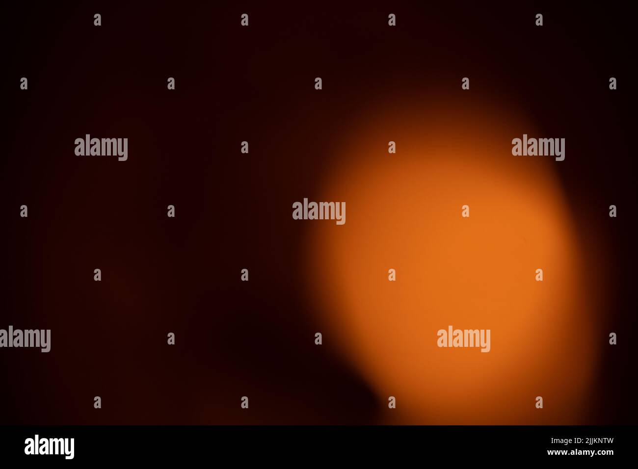 Defocused front plane of an orange light Stock Photo - Alamy