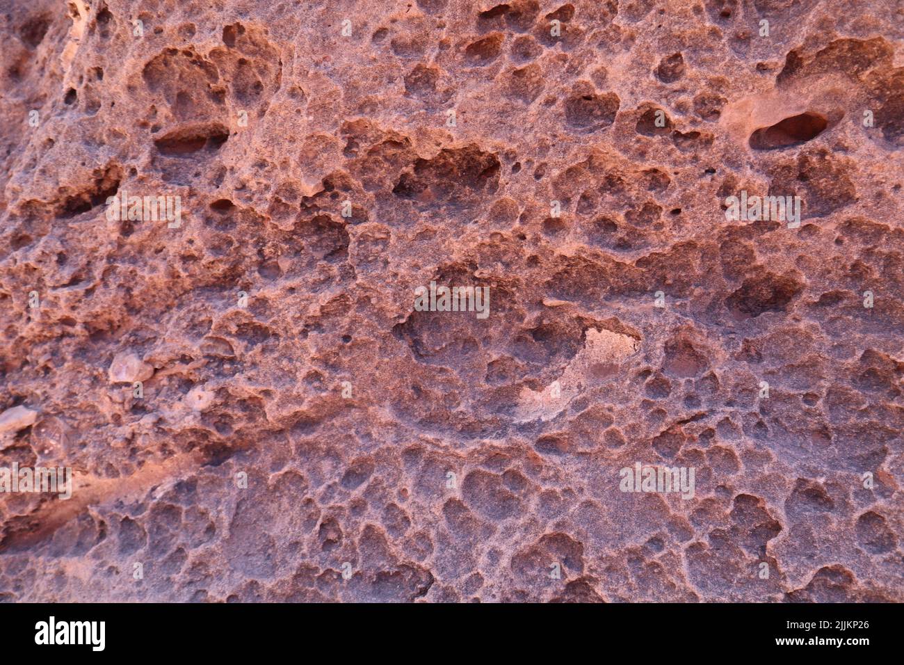 A close up shot of a red rock cratered texture - great for backgrounds ...