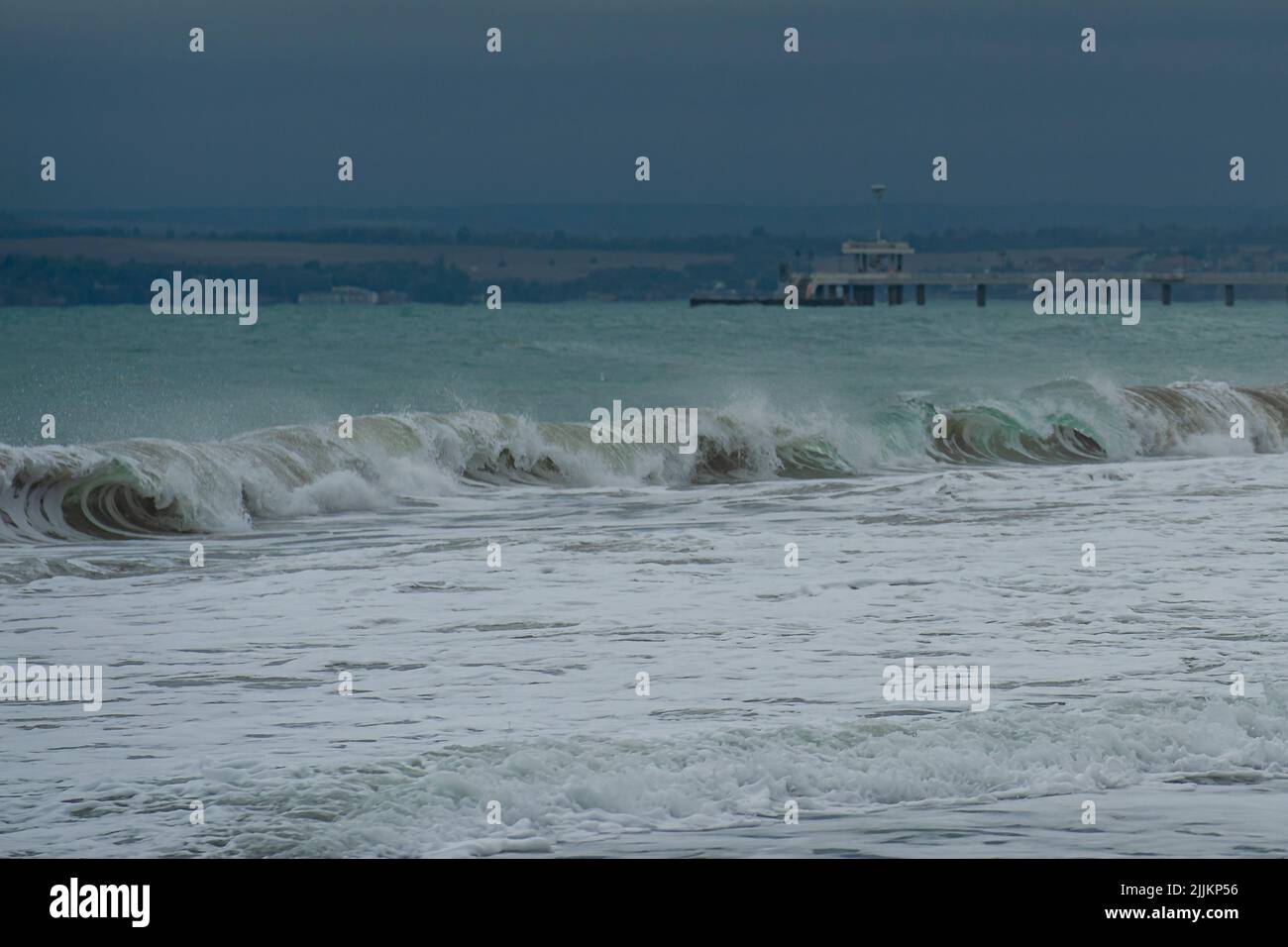 A scenic view of the vast ocean waves on a cloudy weather Stock Photo ...