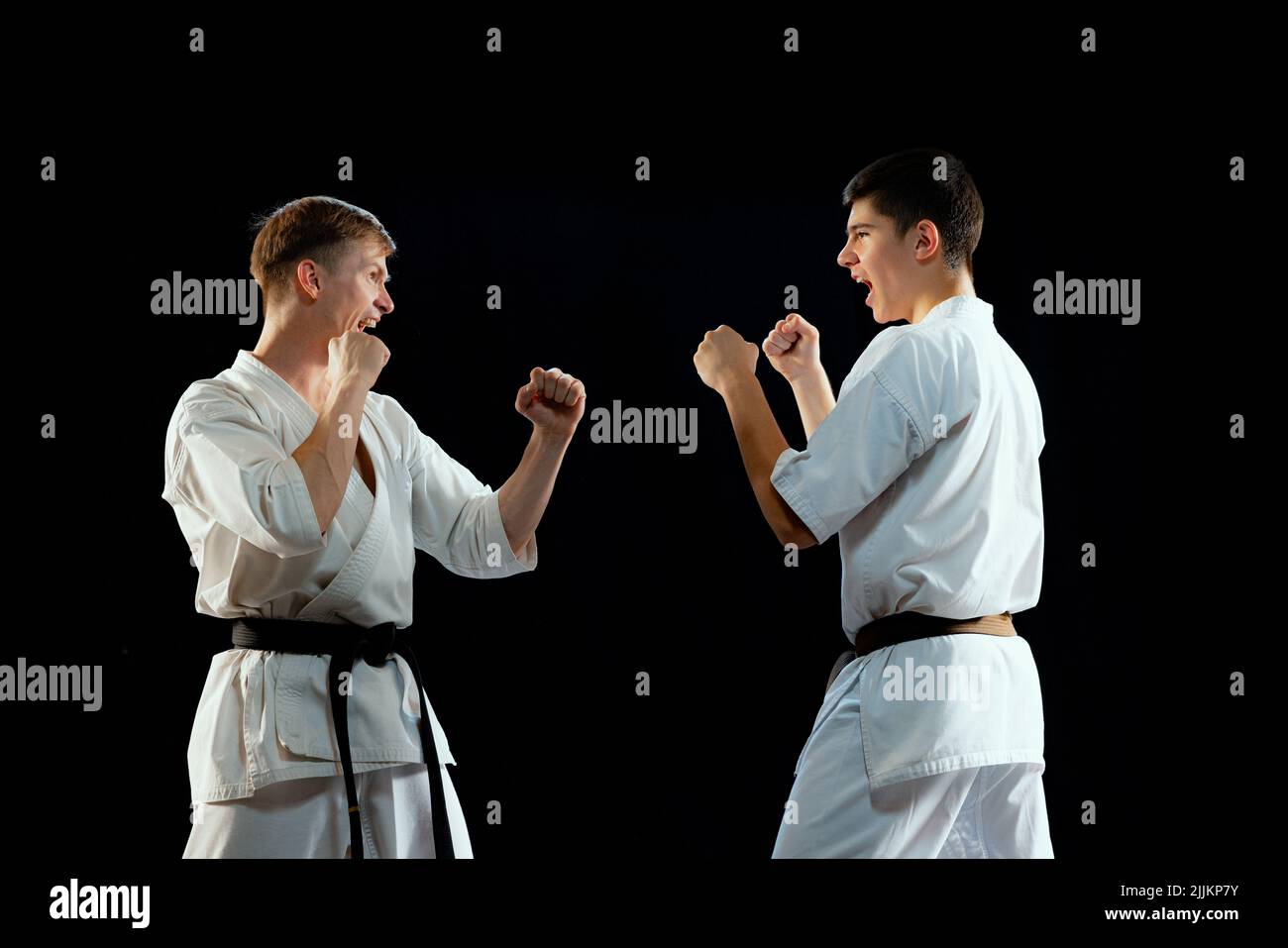 Dynamic portrait of male karate-do fighters in sports uniform training ...