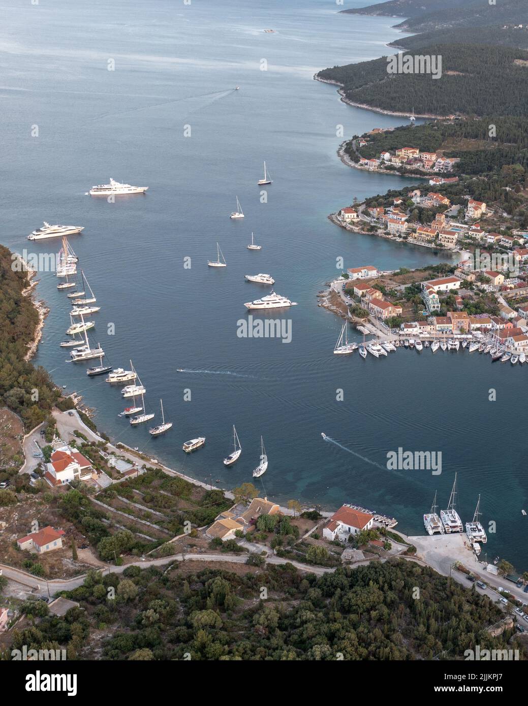 An aerial shot of the coastline with resorts by the boats in the in ...