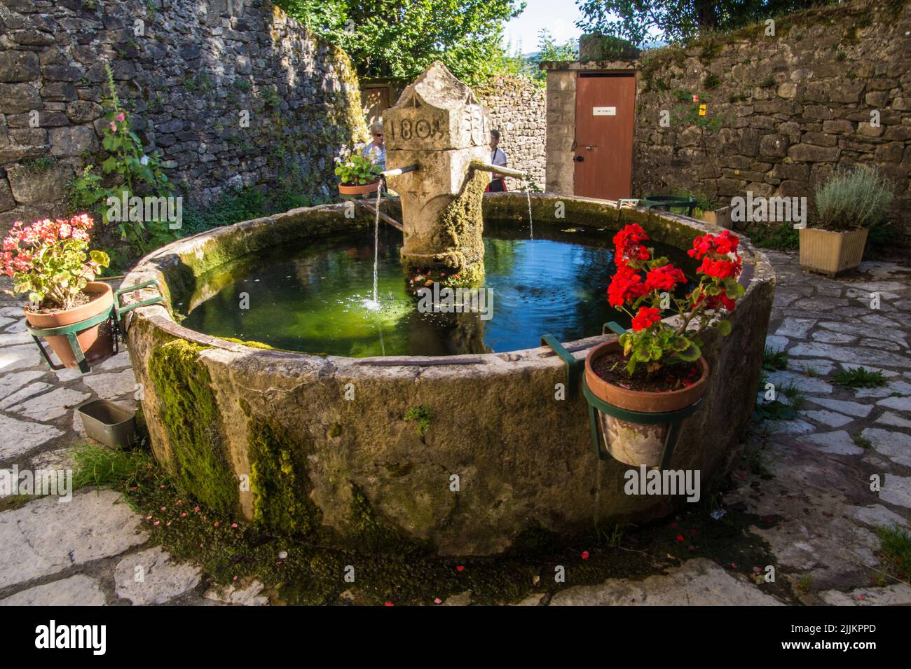 A round small decorative fountain in the yard of a building Stock Photo ...