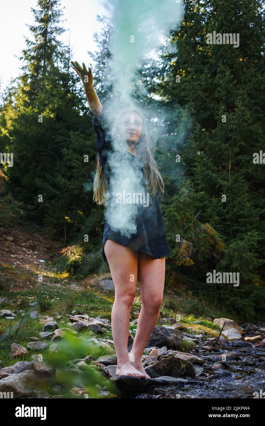 A young Caucasian female splashing powder during a photoshoot in the ...