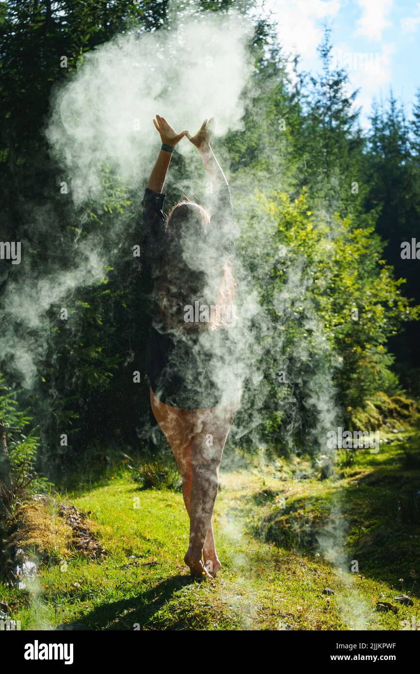 A young Caucasian female splashing powder during a photoshoot in the ...