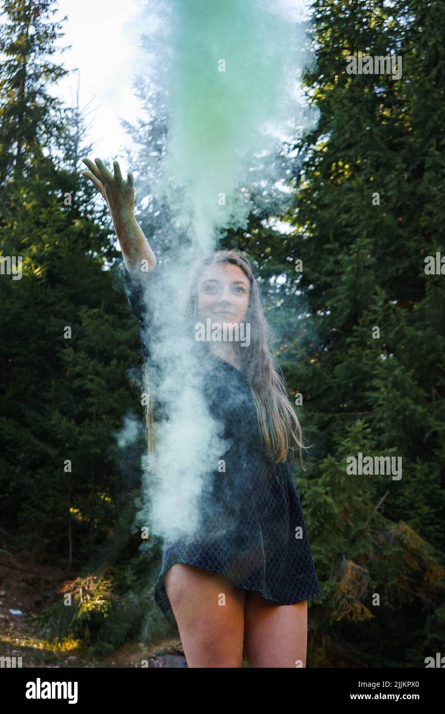 A young Caucasian female splashing powder during a photoshoot in the ...