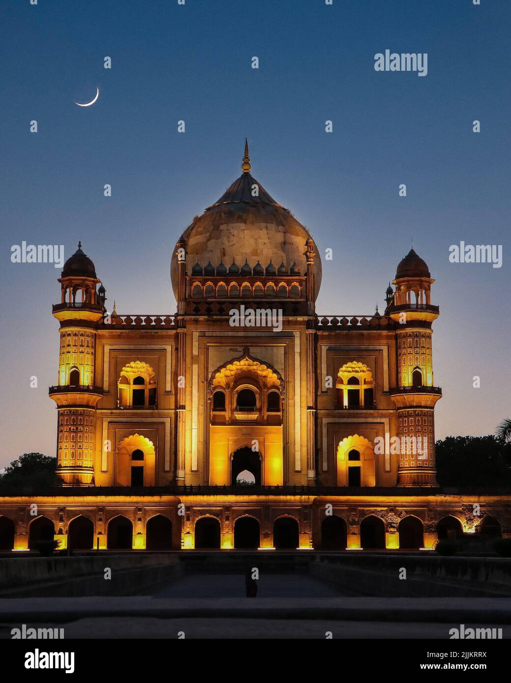 A gorgeous vertical shot of the Safdarjung Tomb with a glowing crescent ...