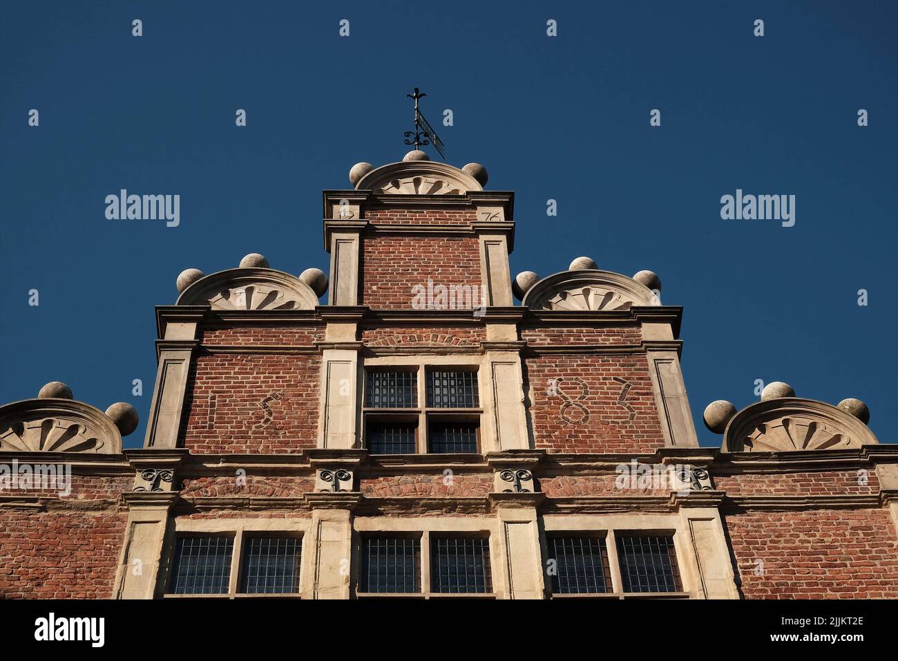 A low angle view of a historical brick building topped with arch-shaped ...