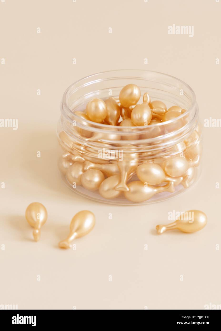 Beauty serum capsules in a jar on light yellow close up. Skincare ...