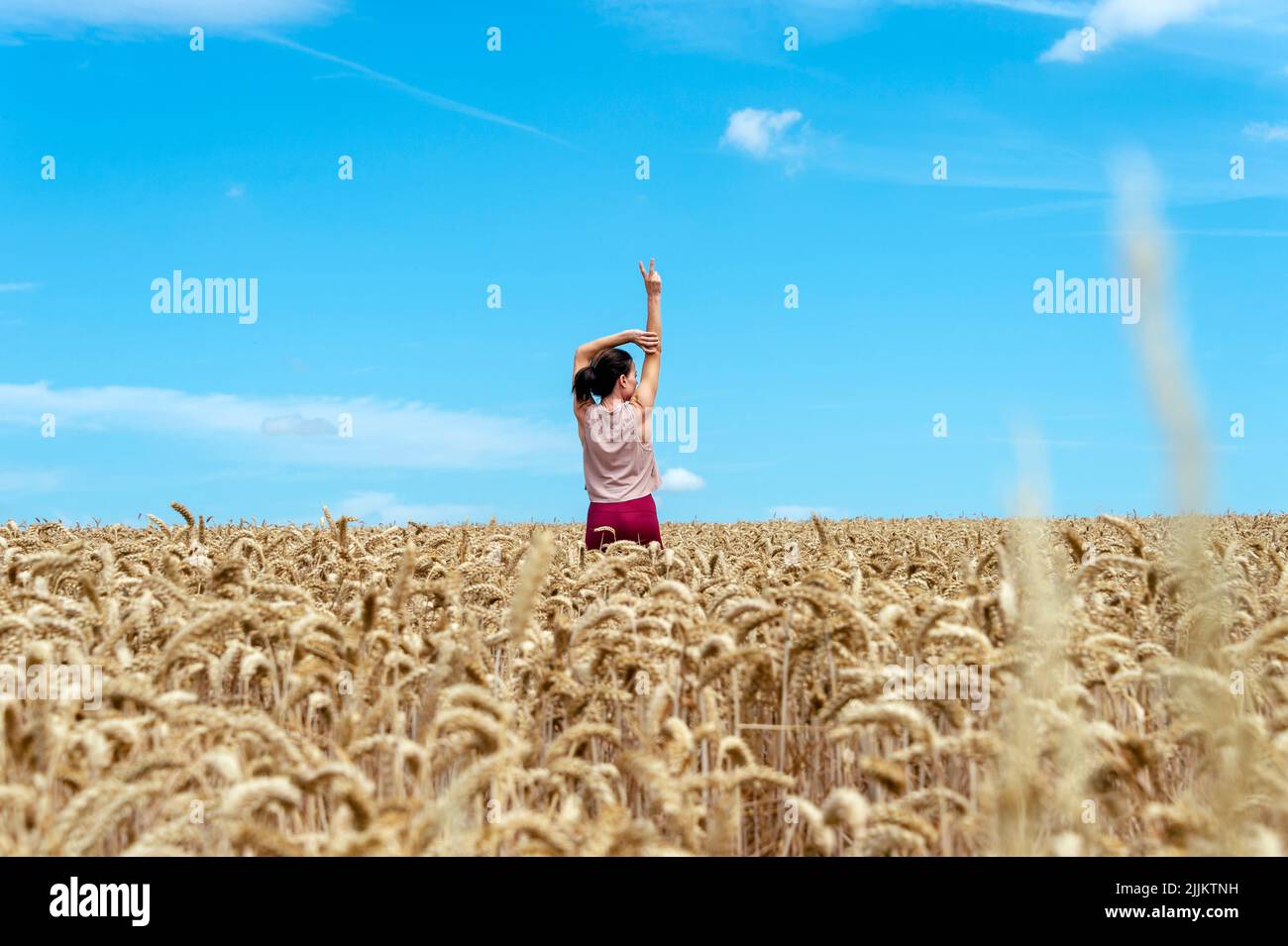 Happy woman feeling free with her arms outstretched, standing in a ...