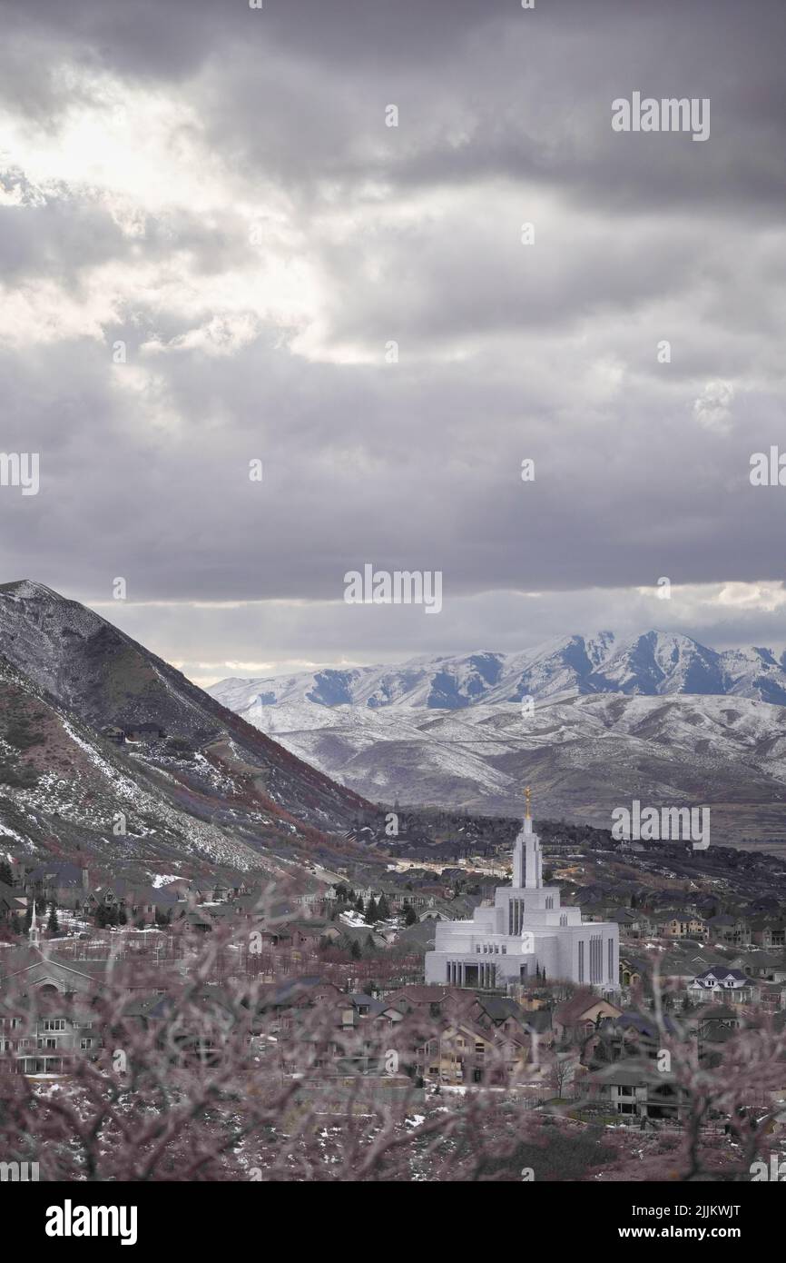 A vertical shot of LDS temple with golden Angel Moroni statue at the ...