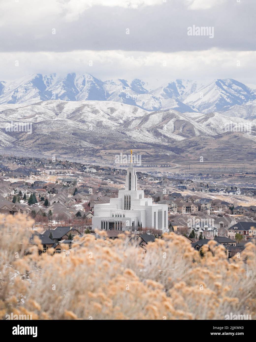 A vertical shot of LDS temple with golden Angel Moroni statue at the ...