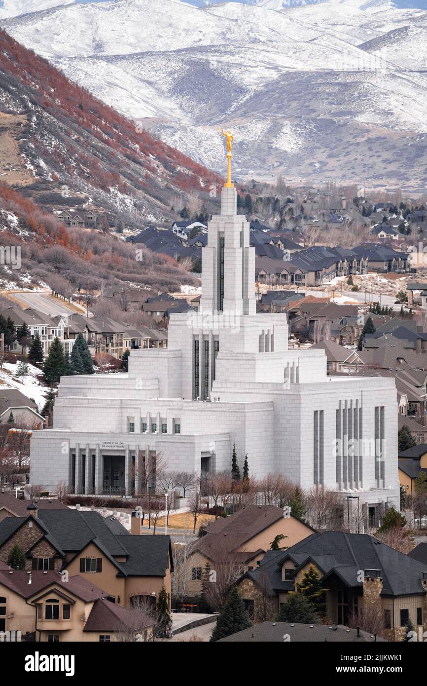 A vertical shot of LDS temple with golden Angel Moroni statue at the ...