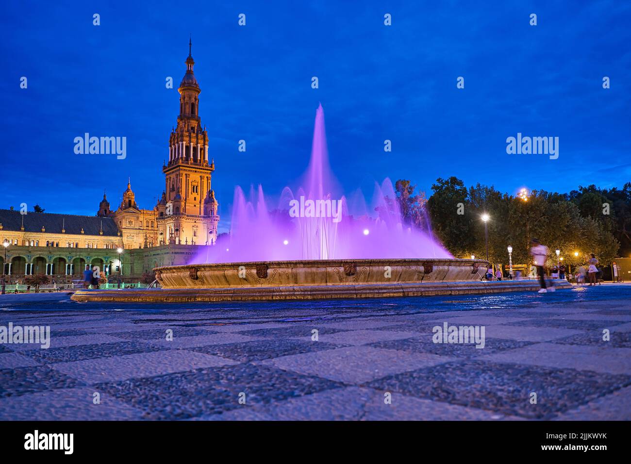 The Seville Plaza and fountains illuminated in the evening in Seville ...