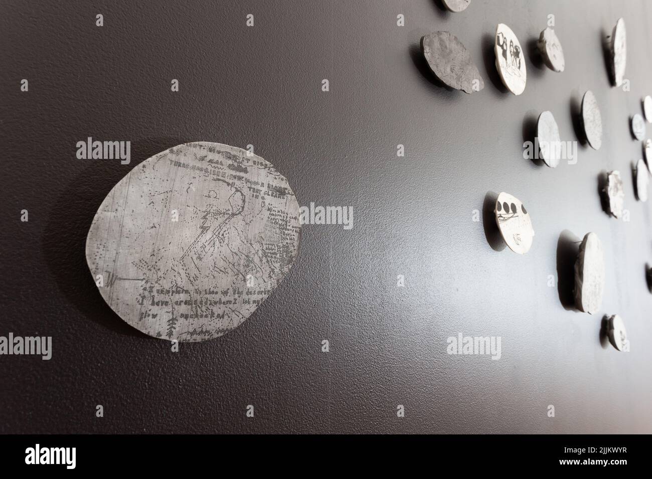 An art installation with abstract stone elements on the smooth wall ...