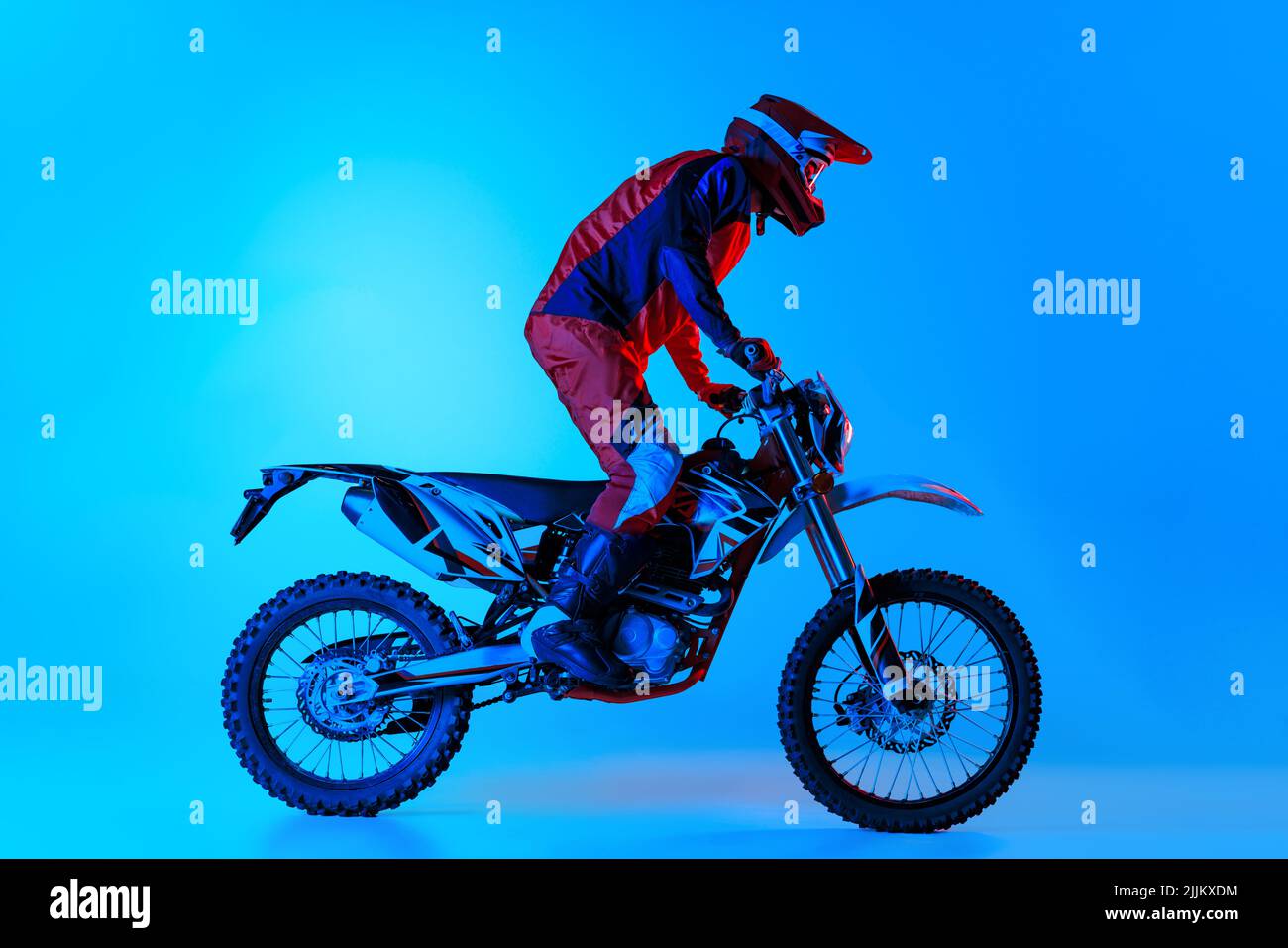 Portrait of young man, biker standing on motorbike, riding isolated ...