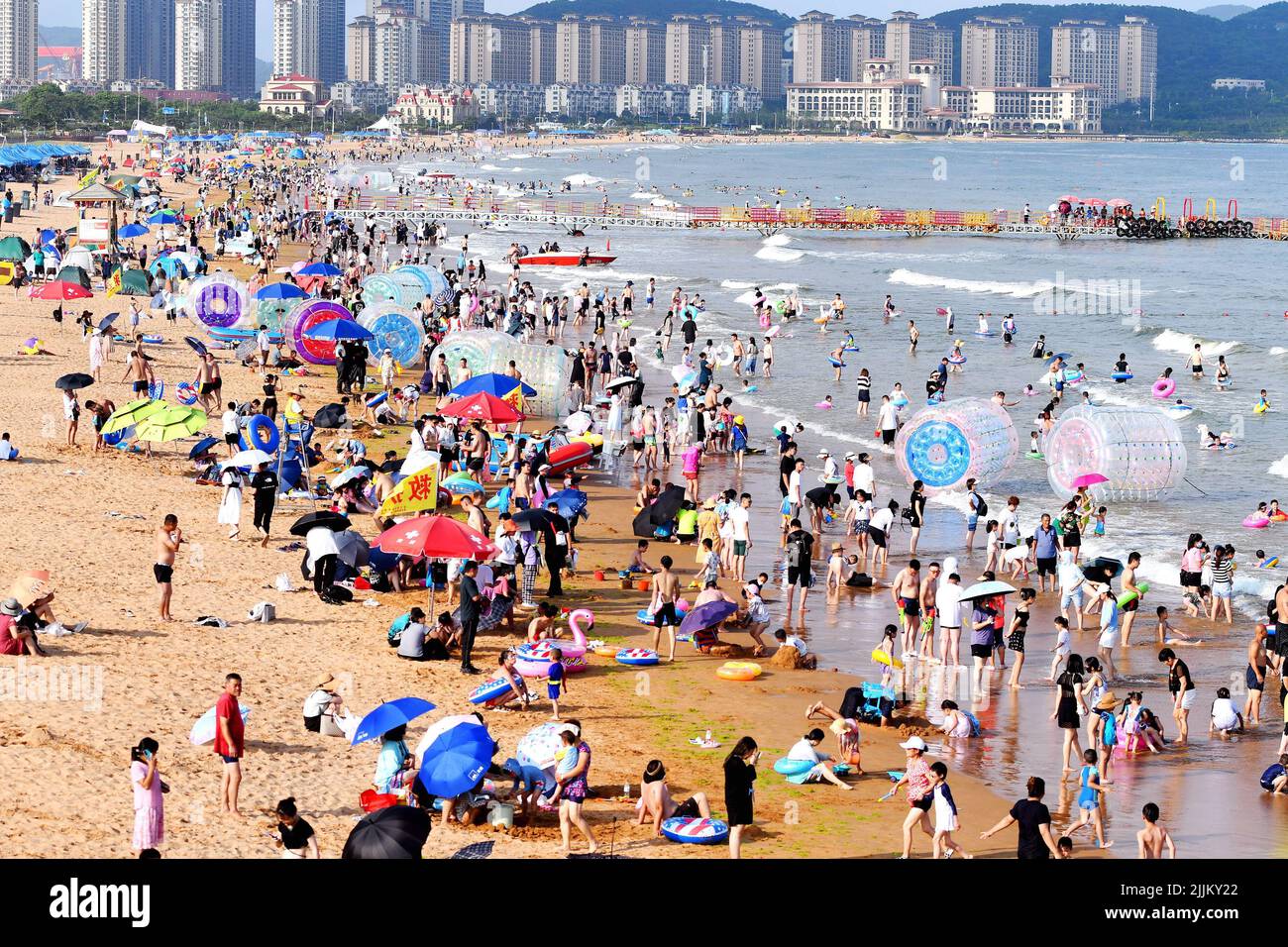 QINGDAO, CHINA - JULY 27, 2022 - A large number of tourists cool off in ...