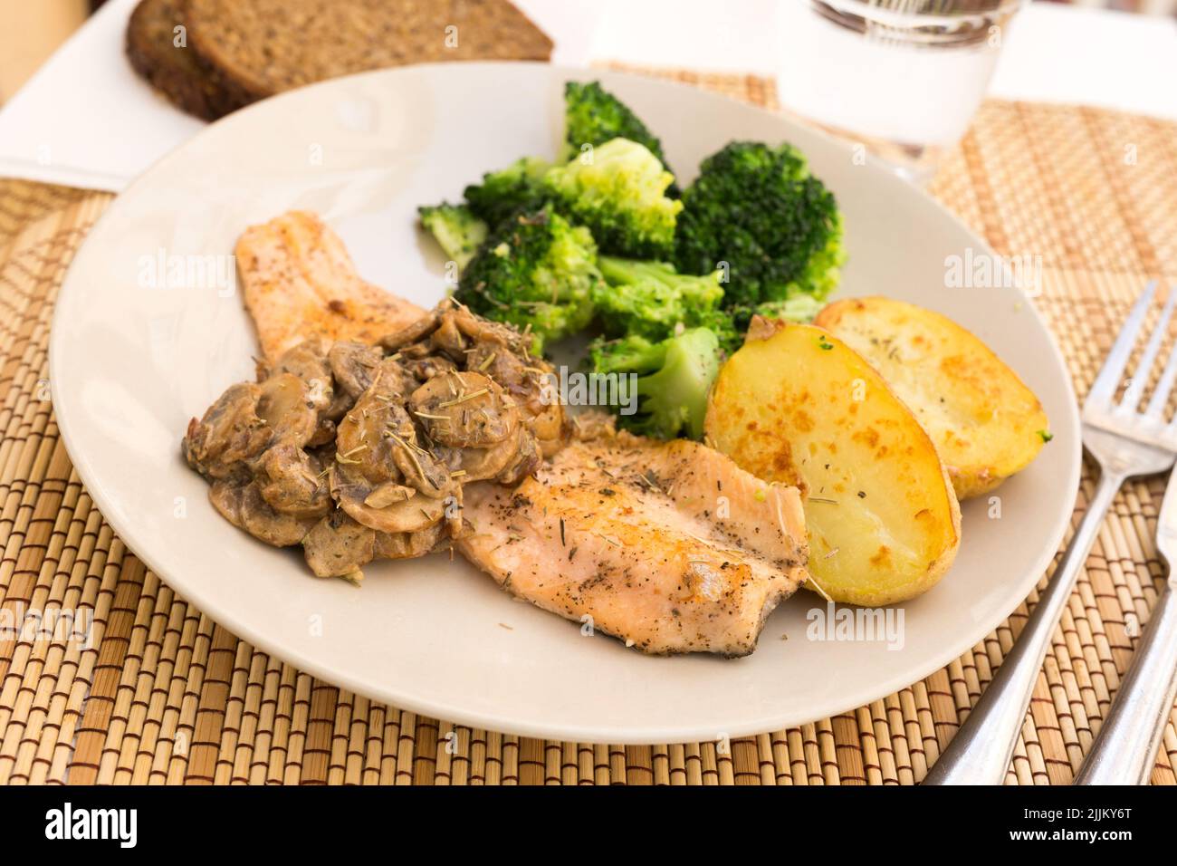 fried river trout fillet with a complex side dish of broccoli, baked ...