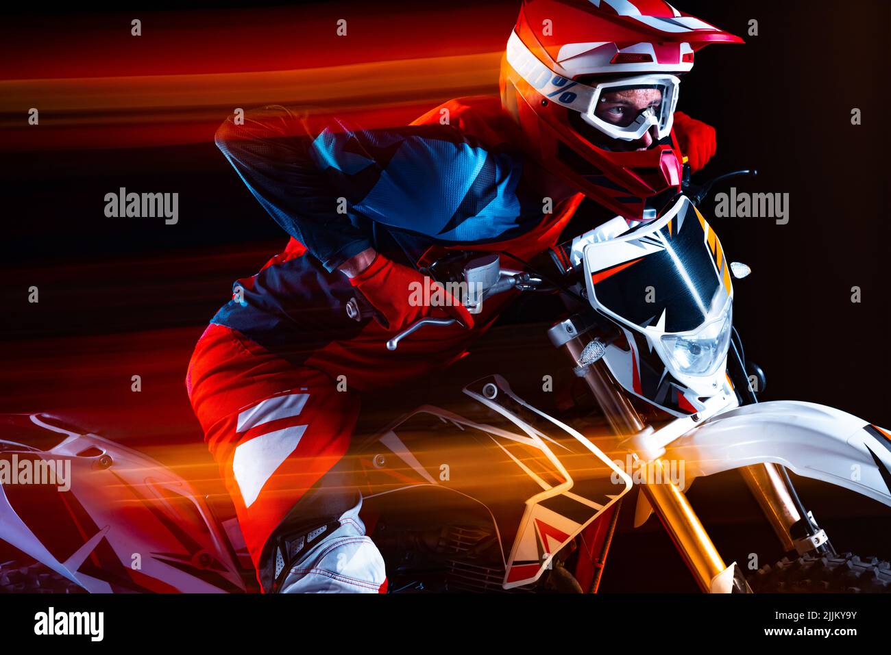 Portrait of young concentrated man, biker riding on cross type ...