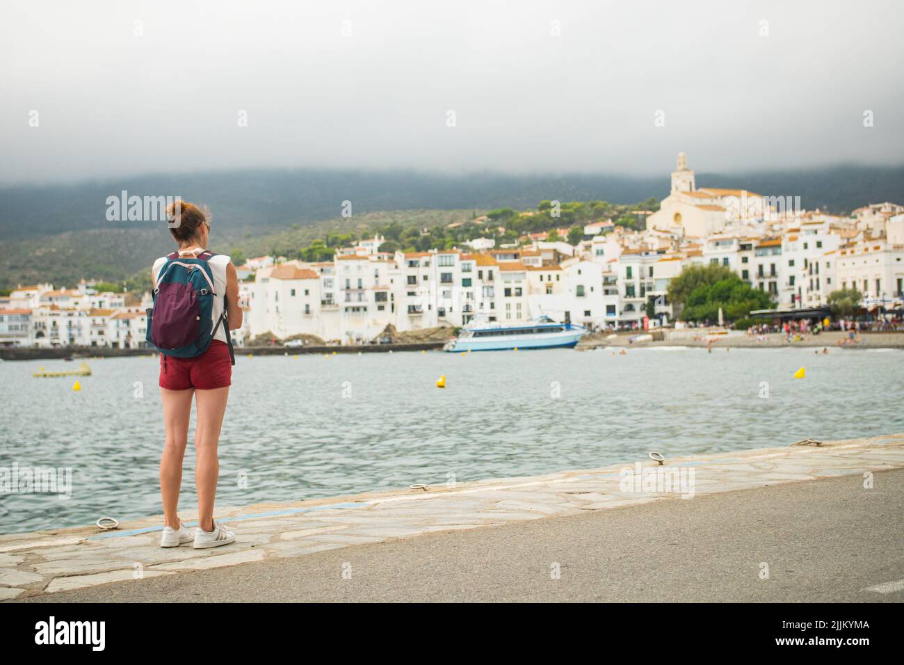 A female looking at Cadaquez old Town on Costa Brava, Spain Stock Photo ...