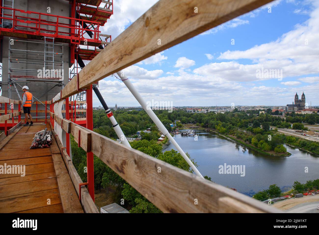 Magdeburg, Germany. 27th July, 2022. A worker stands on a wooden bridge ...