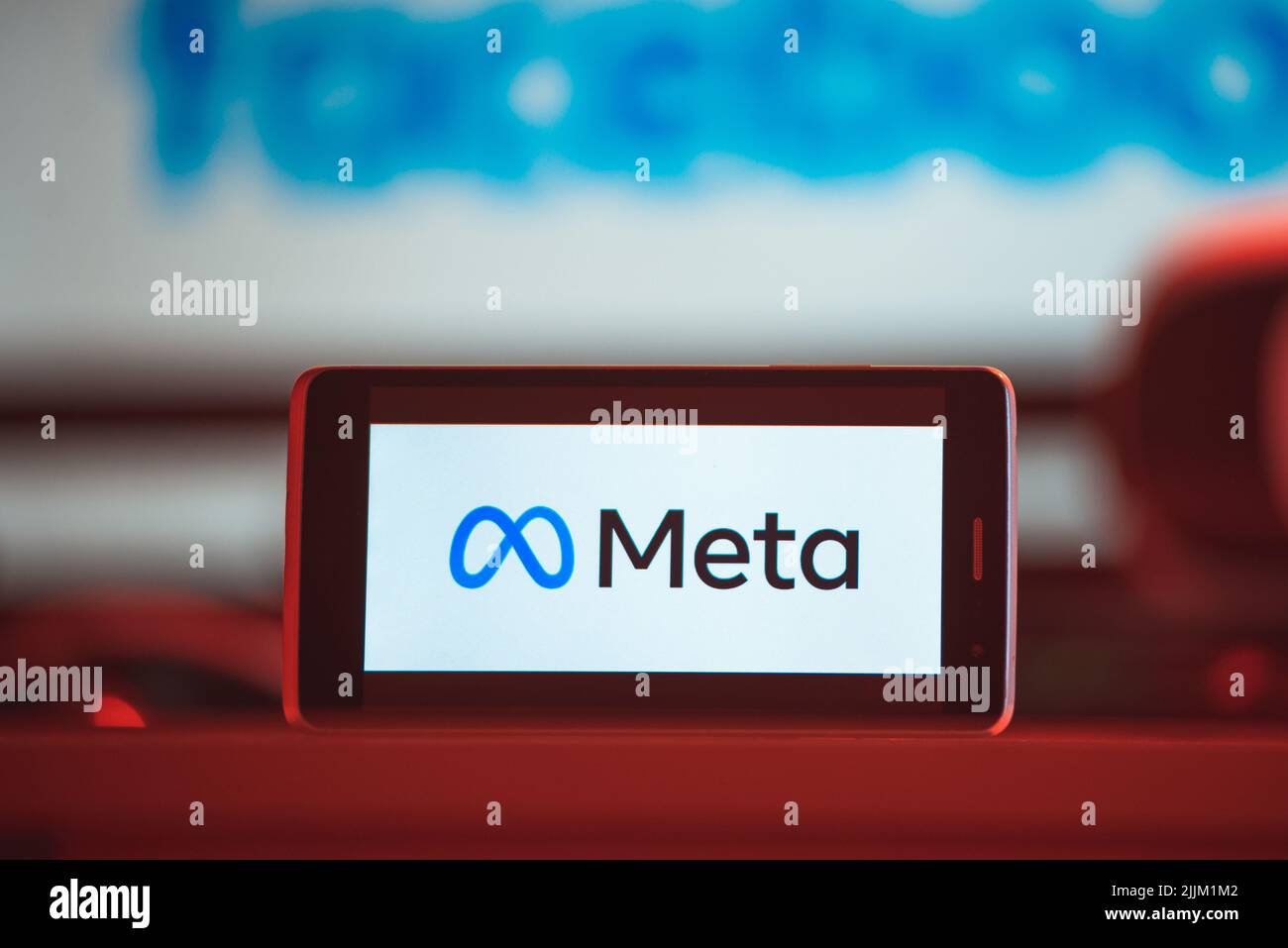 The Facebook rebranding concept with a Meta logo on a phone screen with ...