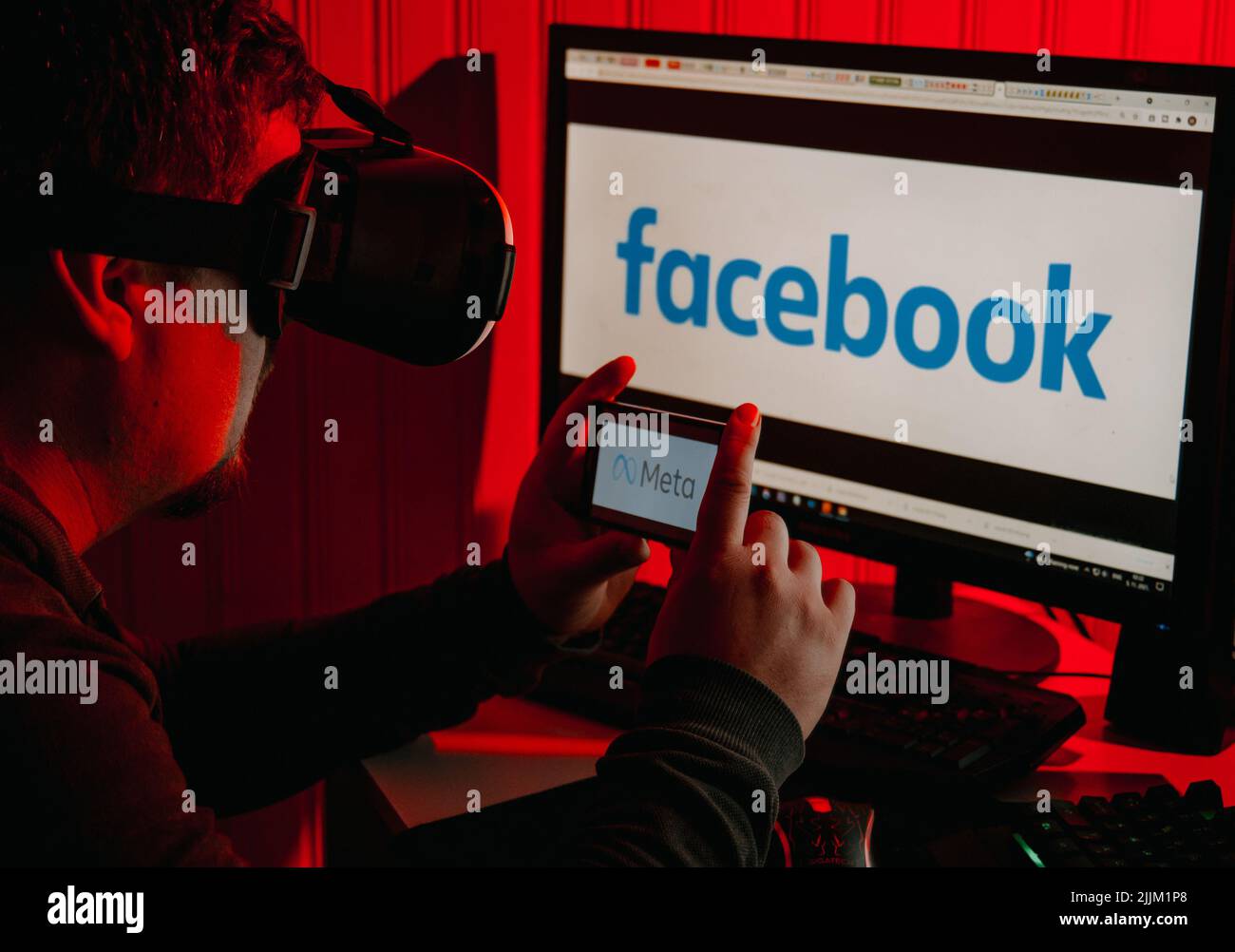 The Facebook rebranding concept with a man holding his phone with Meta ...