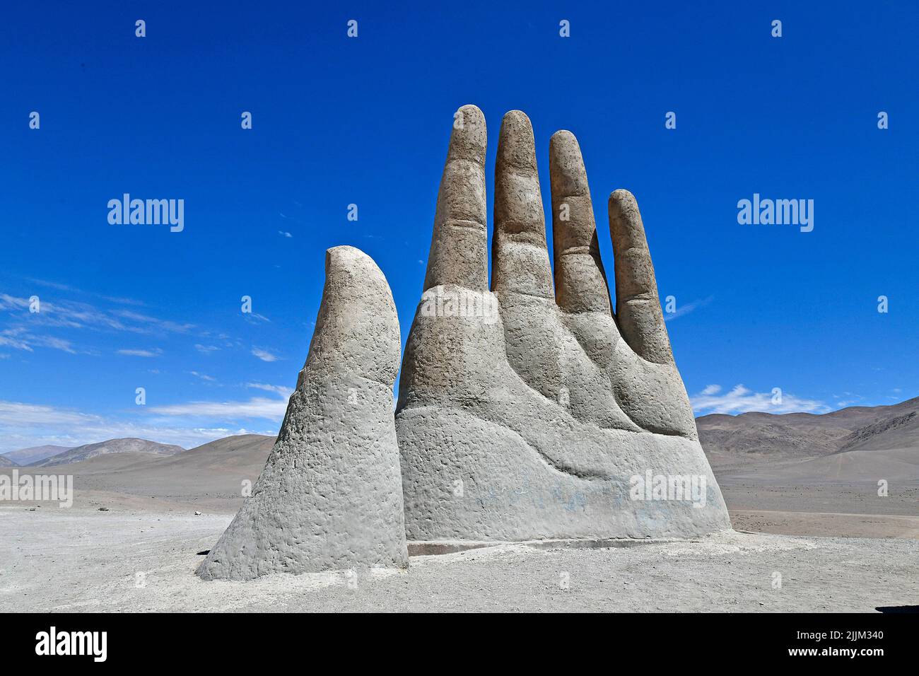A beautiful shot of a sculpture hand located in the Atacama Desert in ...