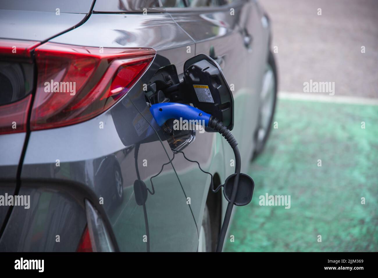 A closeup of the electric car charging cable plugged in Stock Photo - Alamy