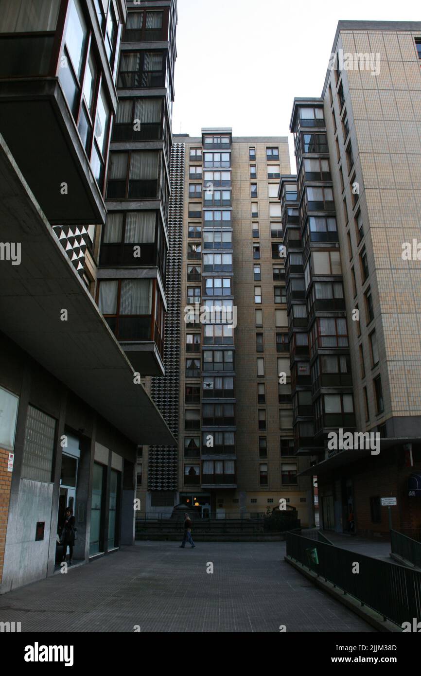 A vertical shot of an alley in between high rise residential buildings ...