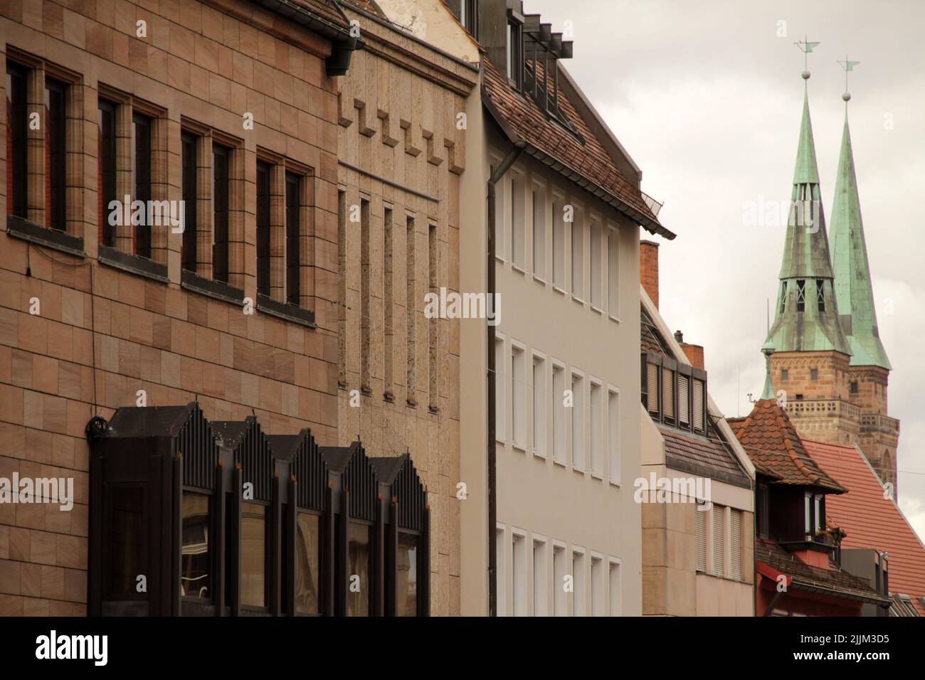 A facade of buildings with St. Lorenz Church background in Nuremberg ...