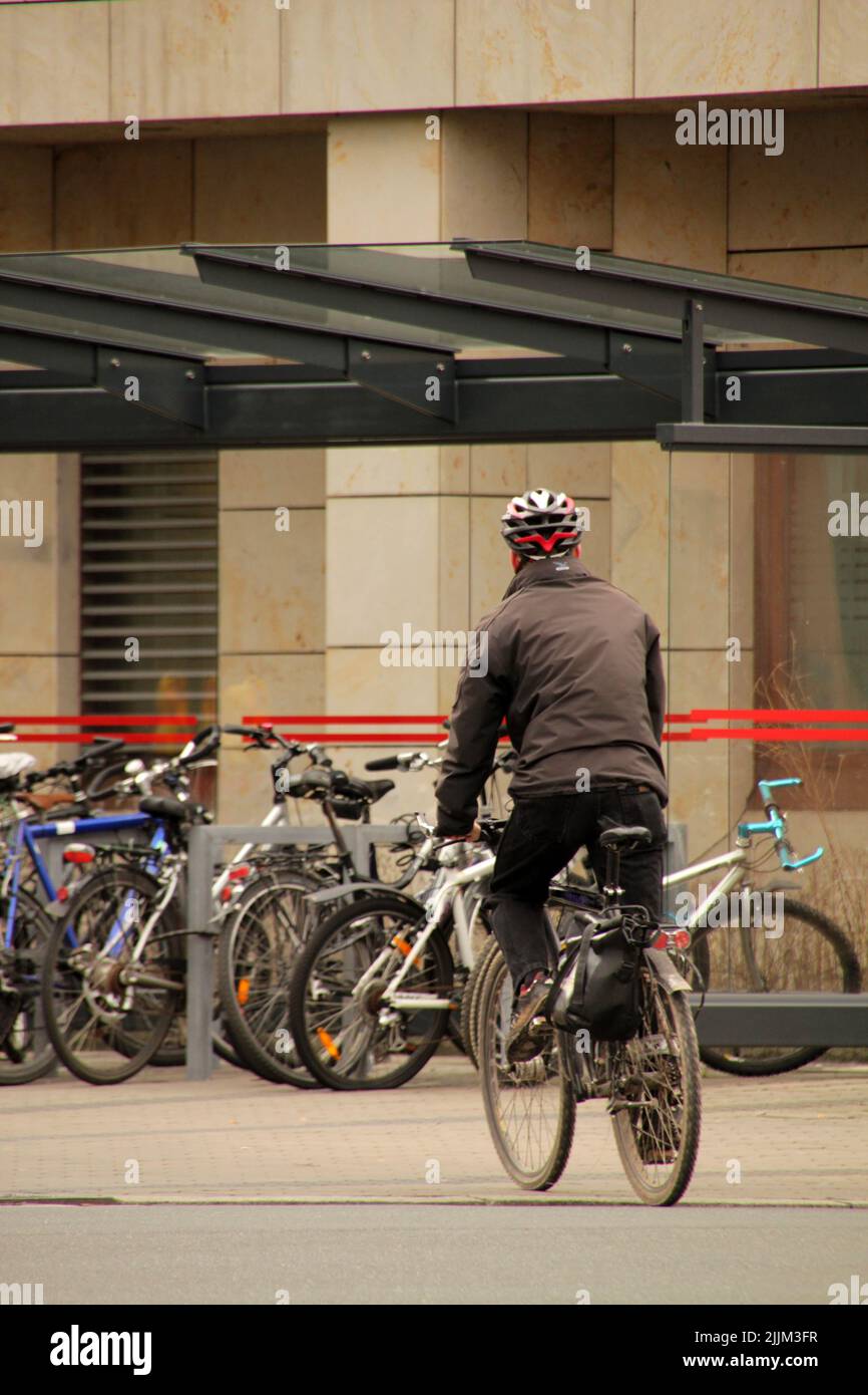A vertical shot of a male biker in an urban environment, Frankfurt ...