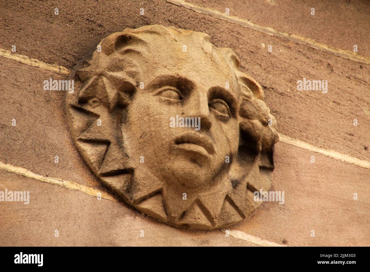 A small man's sculpture on a wall of building in Nuremberg Stock Photo ...