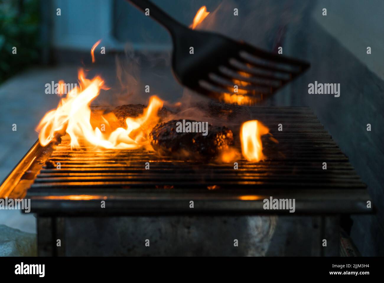 Blurred photo of fire on the barbecue. Close-up of fire view. Blurred ...