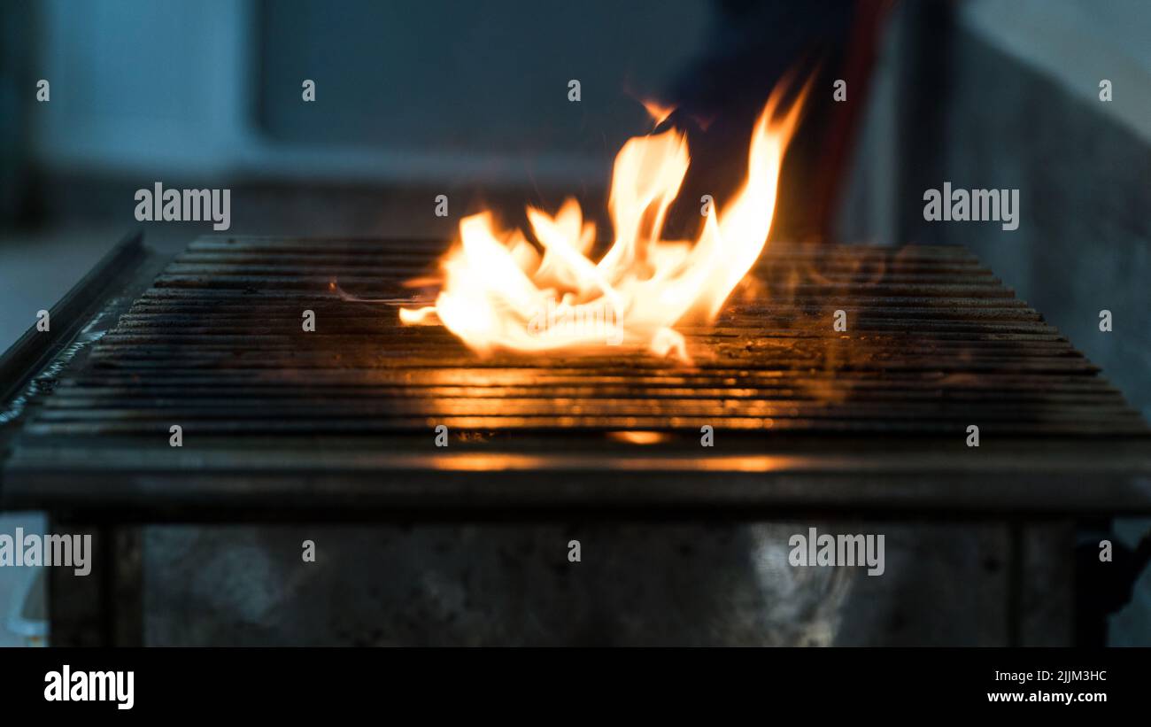 Blurred photo of fire on the barbecue. Close-up of fire view. Blurred ...