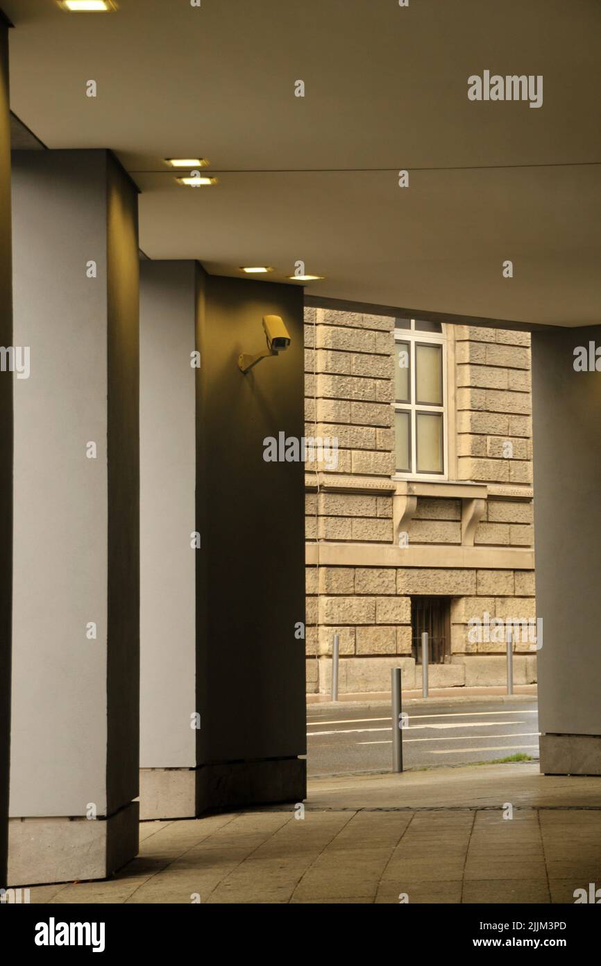 A vertical shot below a building of a camera on the column and outside ...
