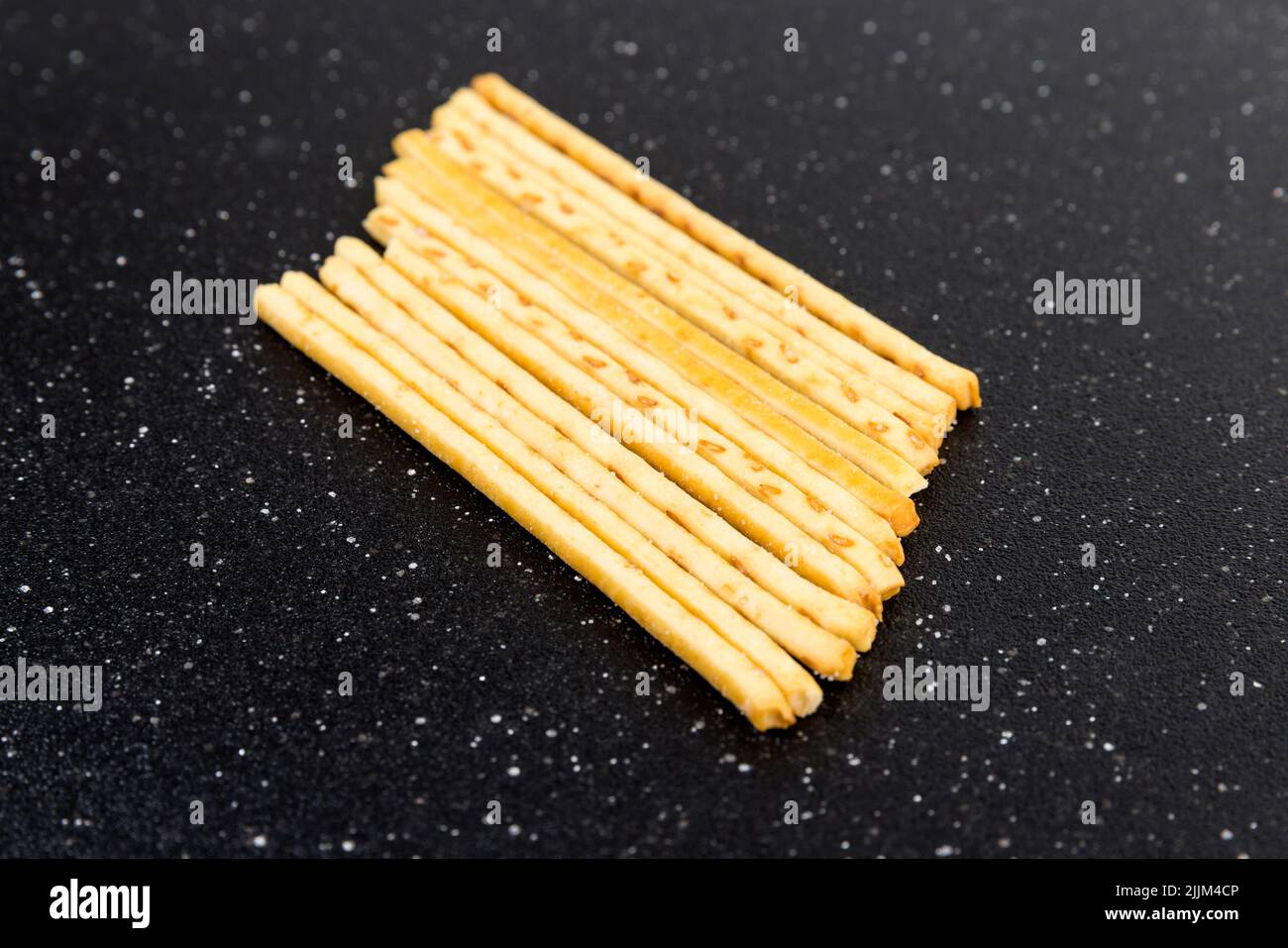 Corn snack sticks piled on a black cutting board Stock Photo - Alamy