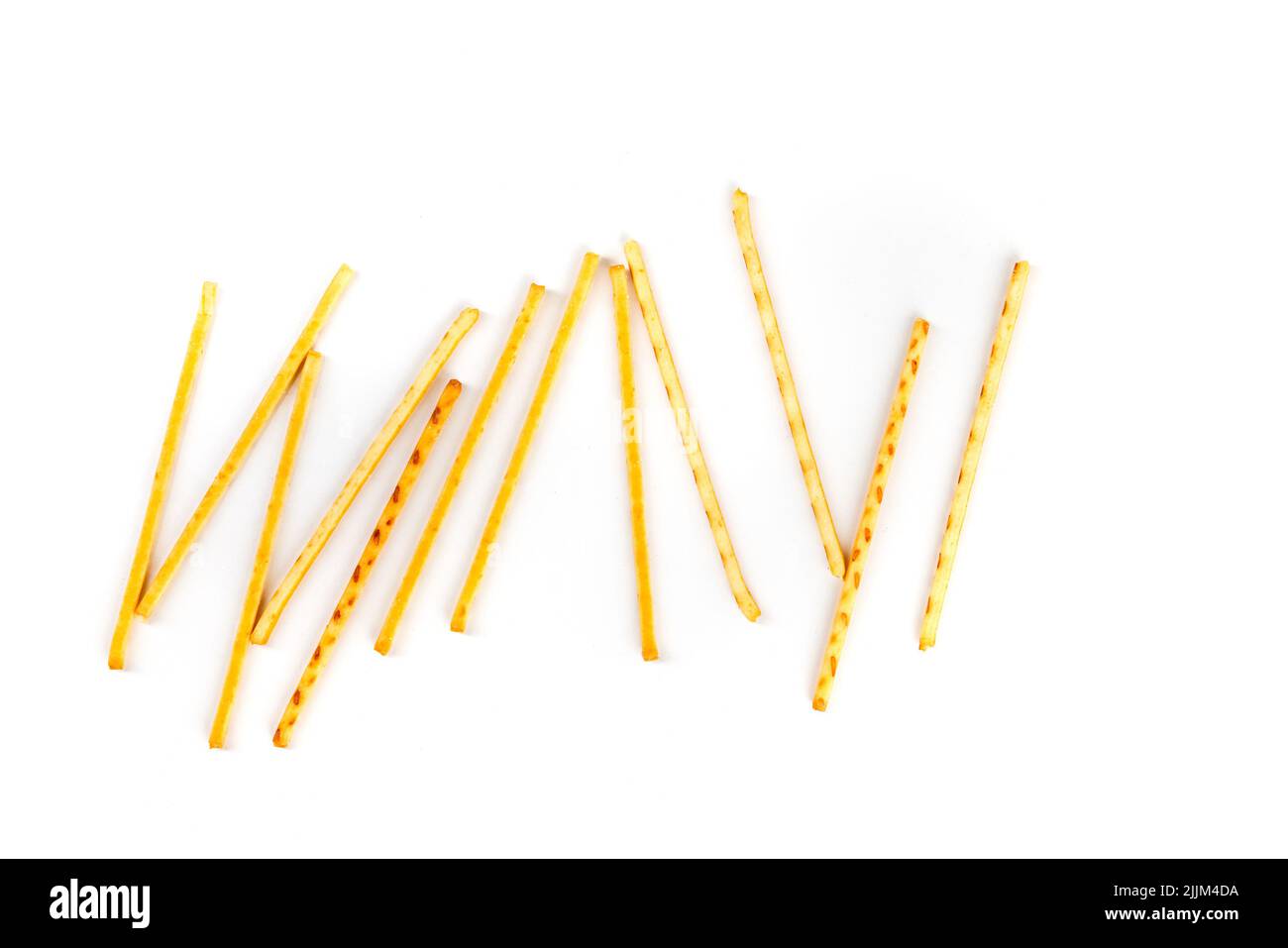 Scattered yellow corn snack sticks top down view isolated over white ...