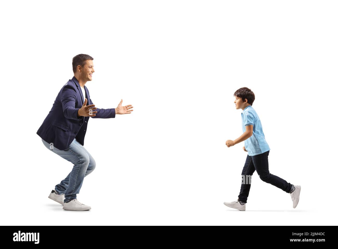 Full length profile shot of a boy running to meet his happy father ...