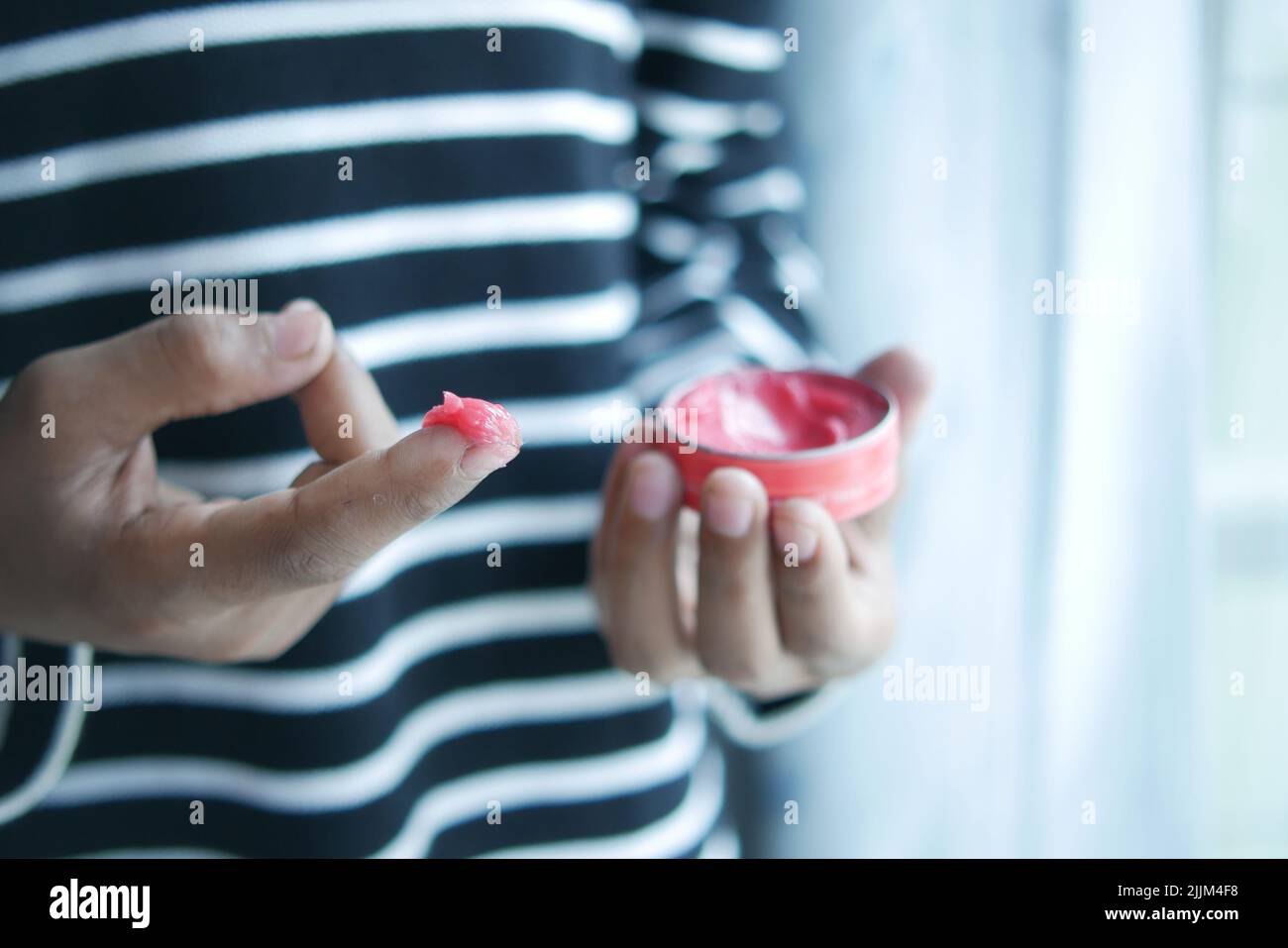 Close up of man hand using petroleum jelly Stock Photo - Alamy