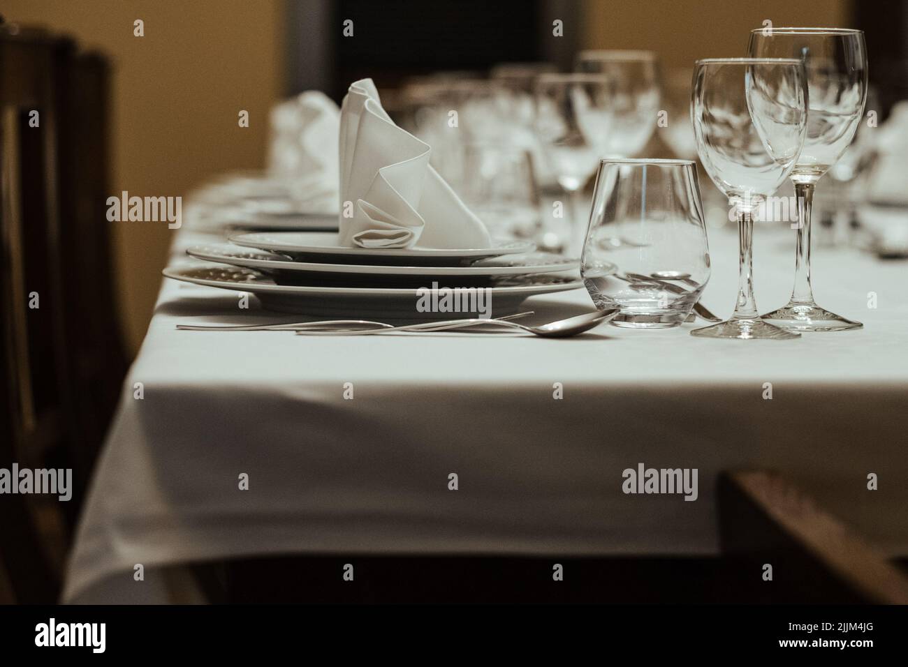 An elegantly arranged dinner table with many plates Stock Photo - Alamy
