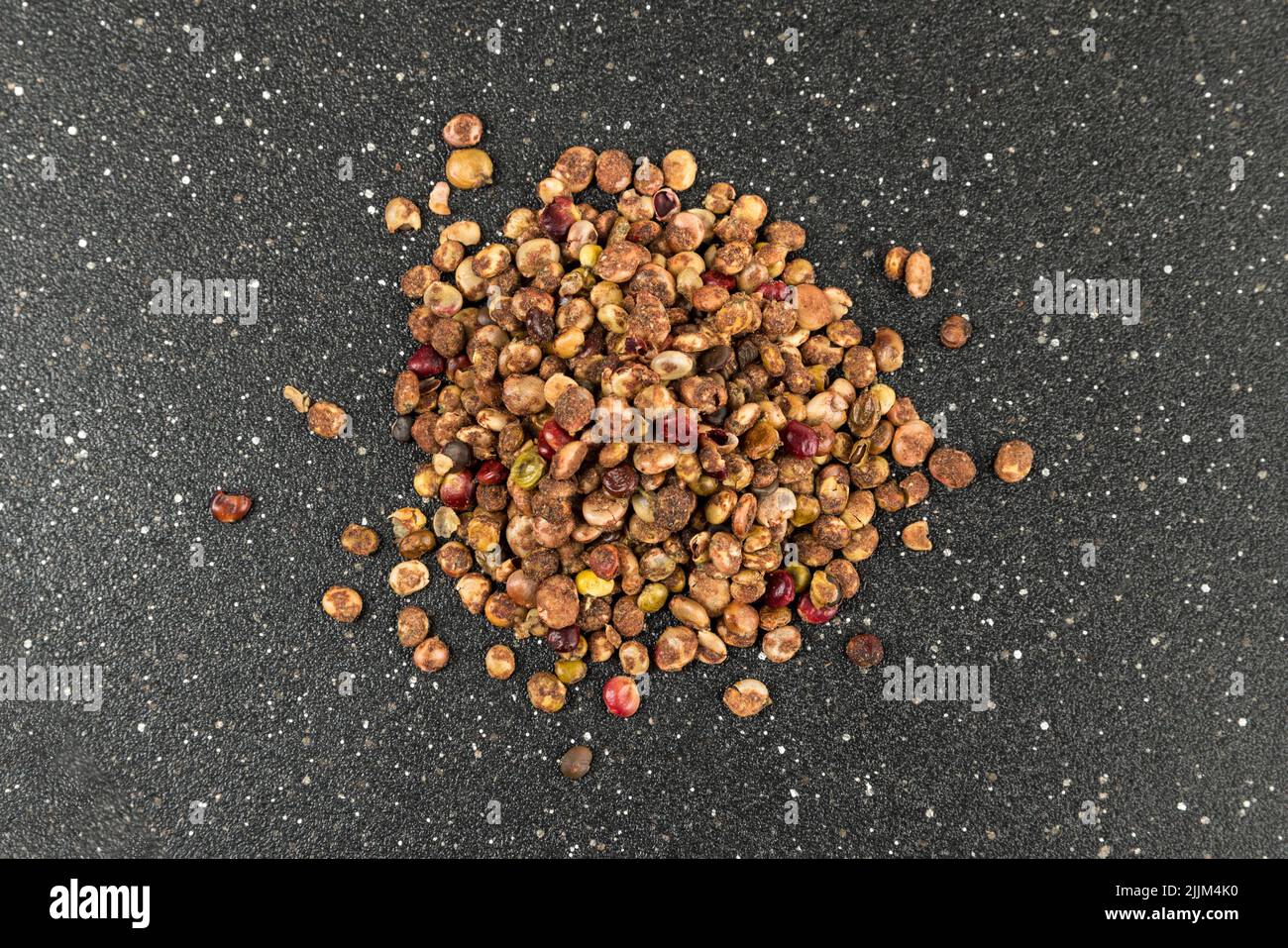 Whole dried sumac berries top down view on a black cutting board Stock ...