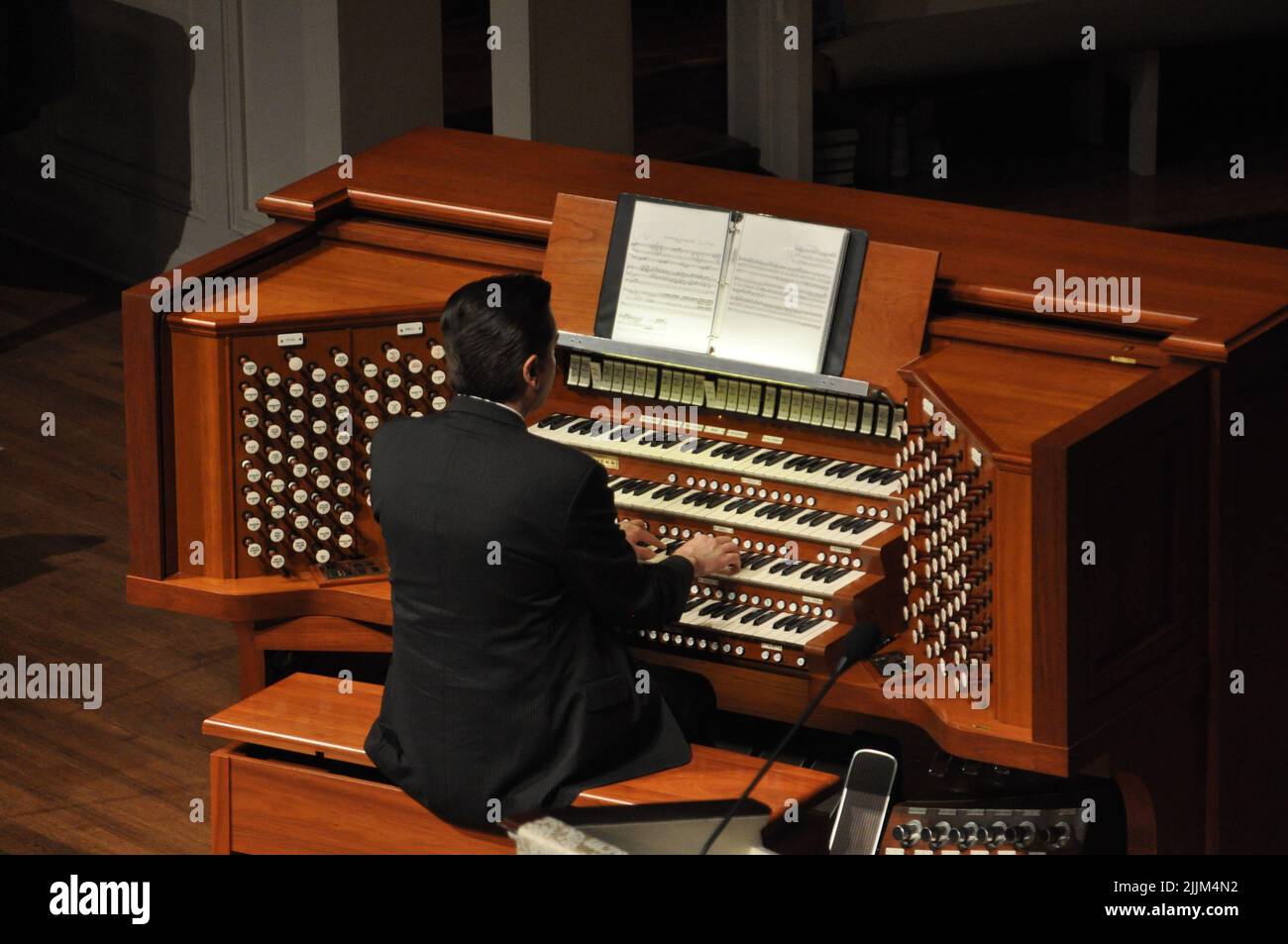 A closeup of the organist playing a very big organ. Memphis, United ...
