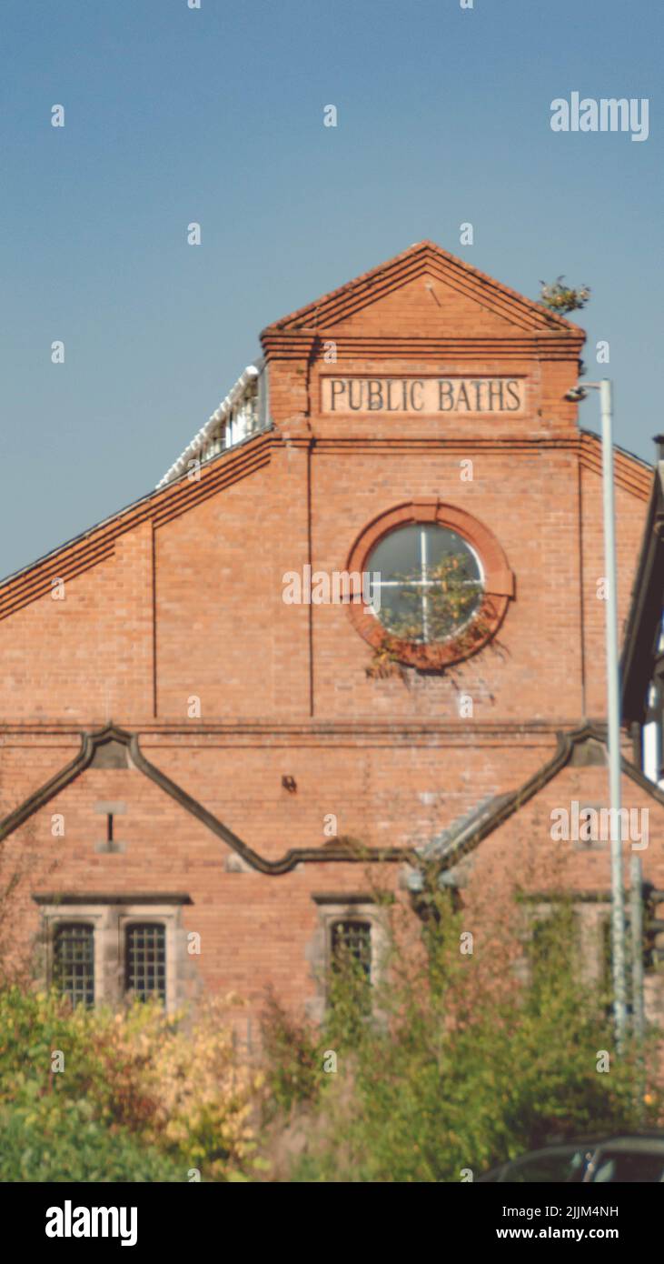 A closeup of Public baths building with a blue cloudless sky background ...