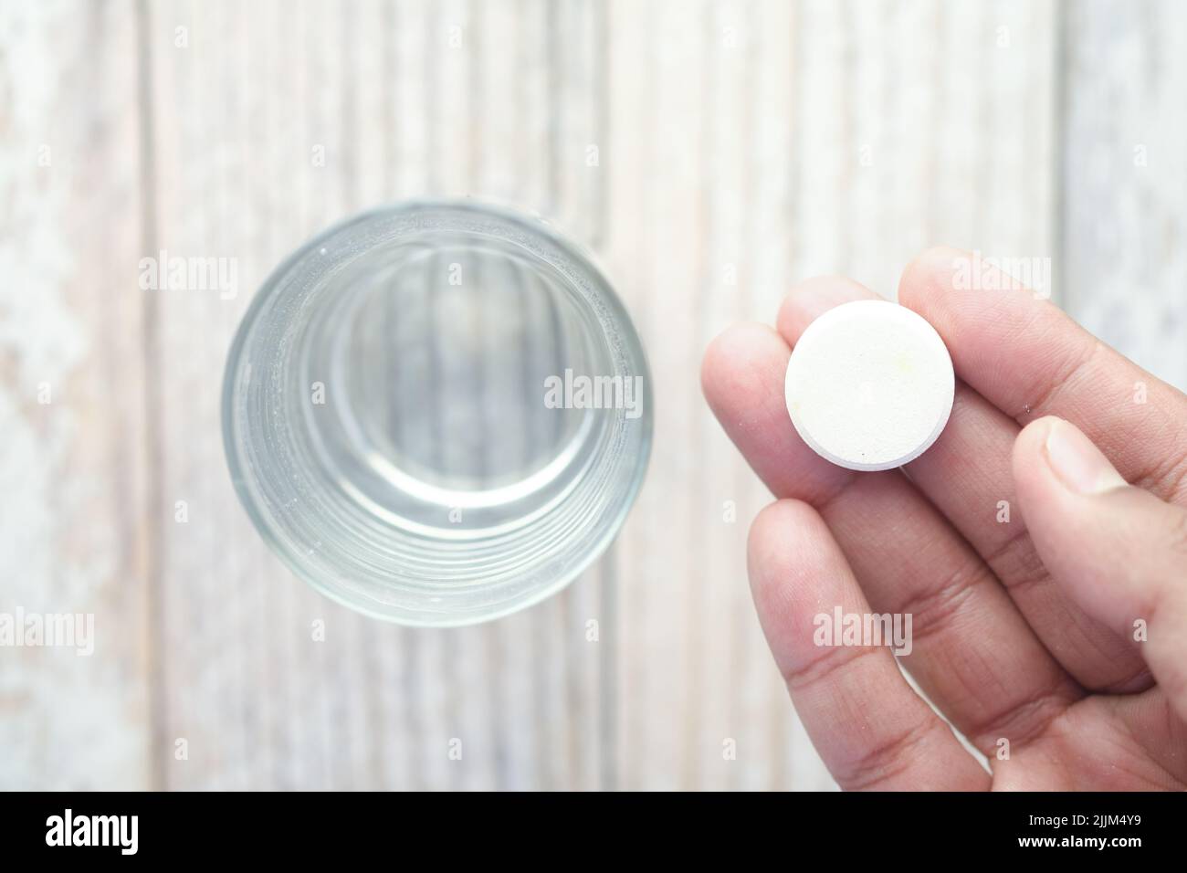 Effervescent soluble tablet pills and glass of water Stock Photo - Alamy