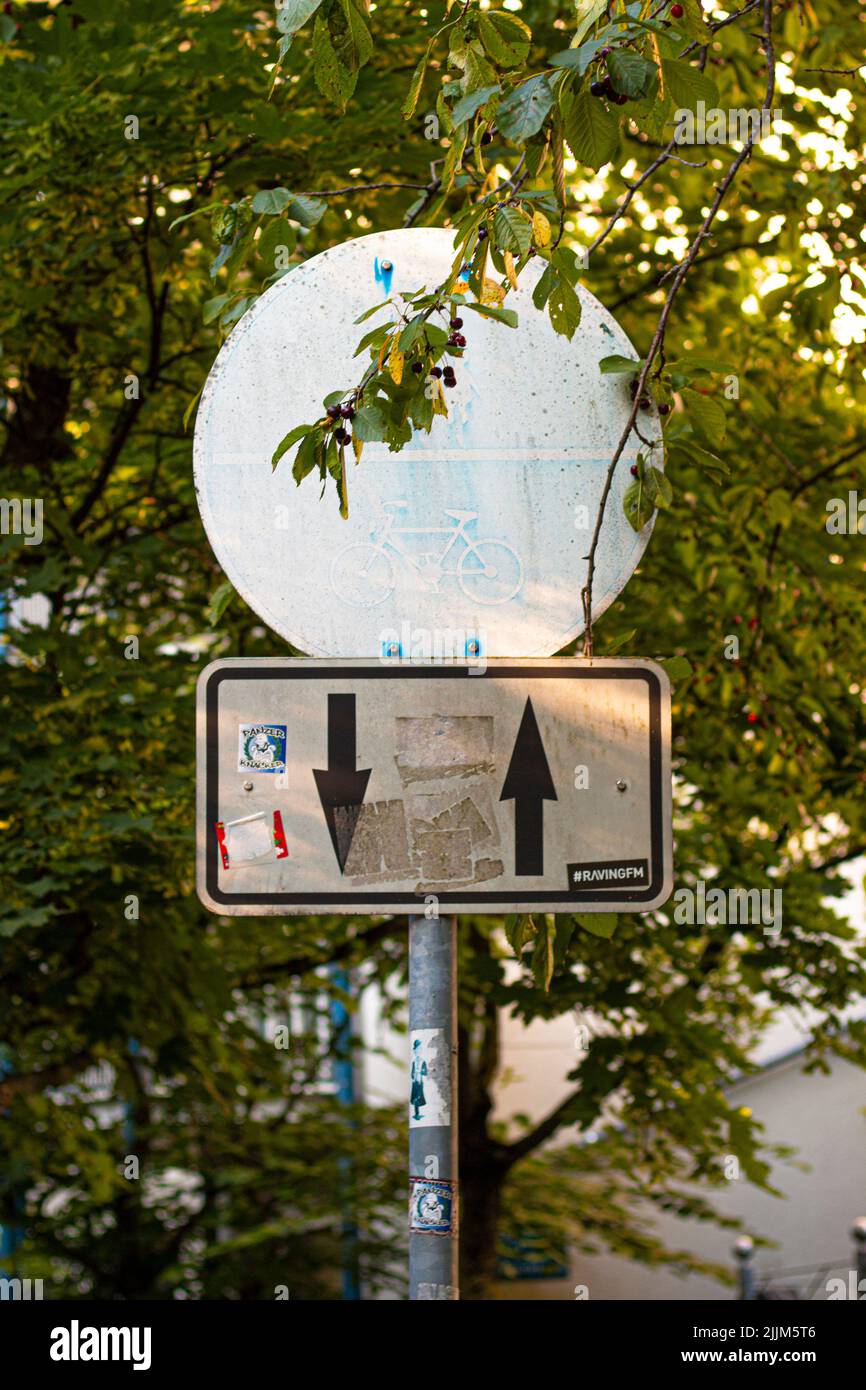 A vertical shot of a bleached out sign for pedestrian and bike zone ...