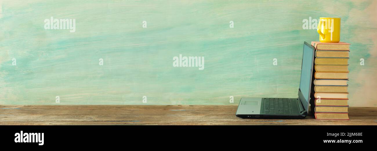 laptop computer and stack of books,home office,business,education ...