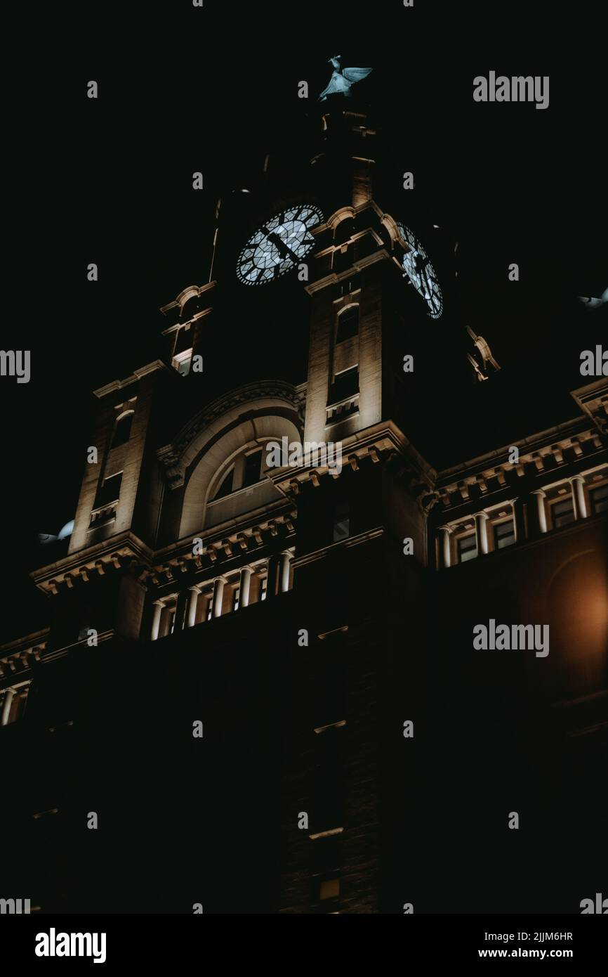 A clock tower at night Stock Photo - Alamy