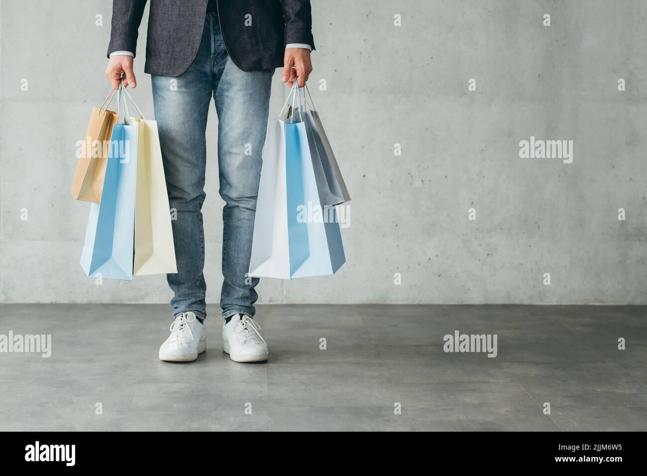 shopaholic consumerism multiple bags man hands Stock Photo - Alamy