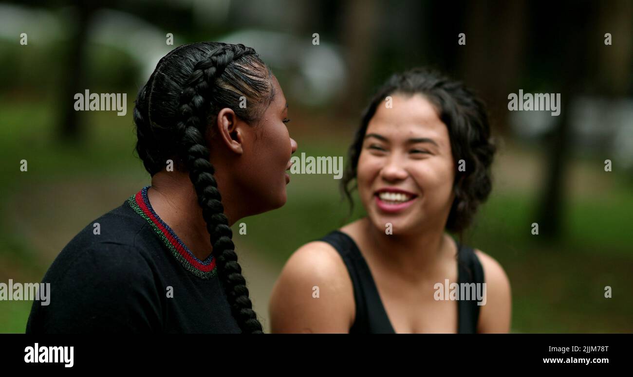 Candid female friends talking outside, real life laugh and smile Stock ...