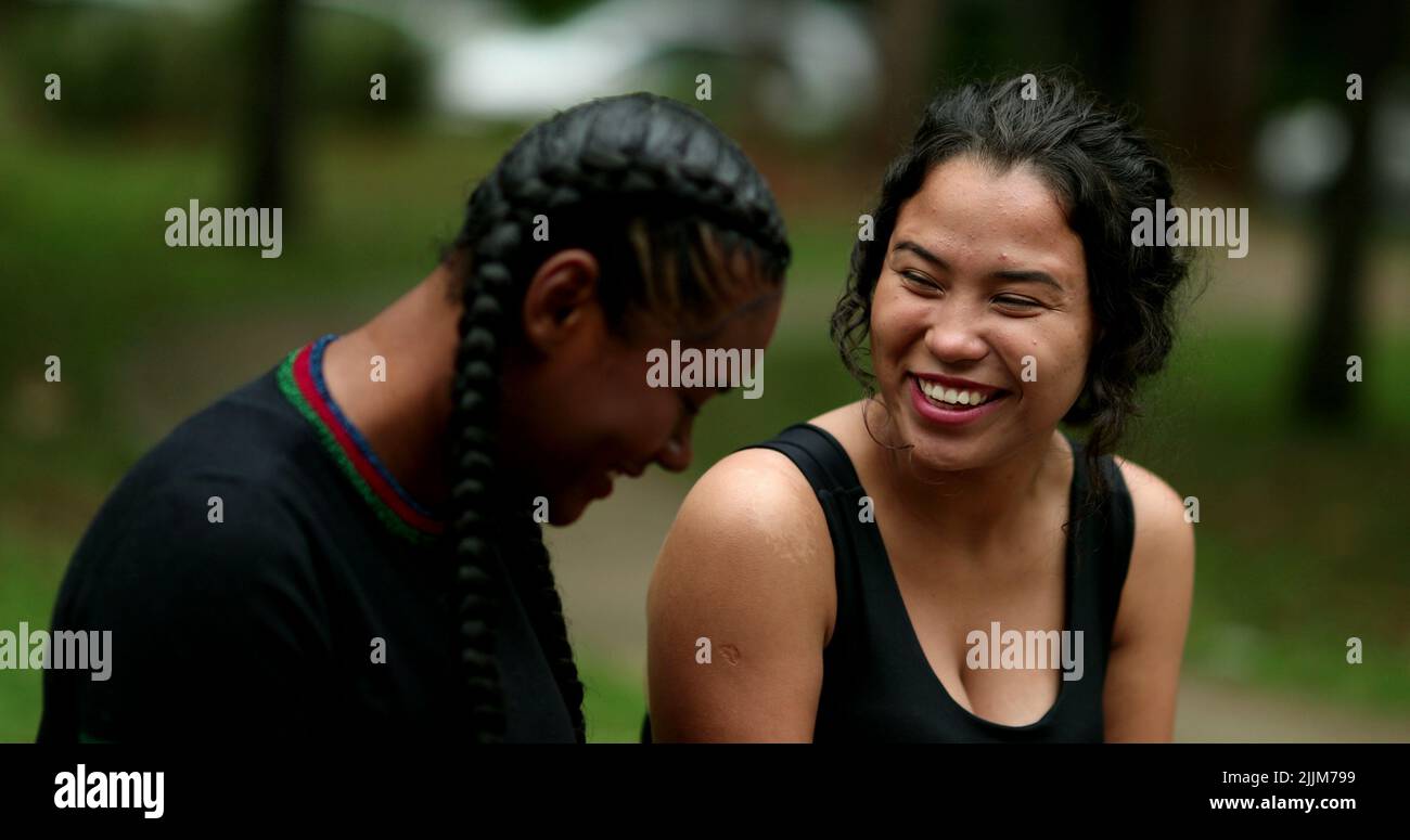 Candid female friends talking outside, real life laugh and smile Stock ...